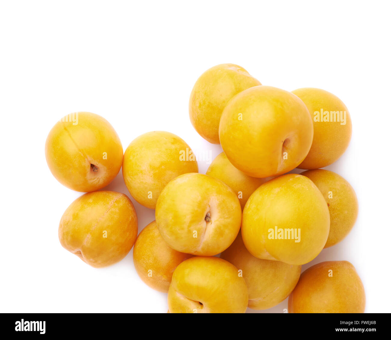 Pile of multiple yellow plums isolated Stock Photo - Alamy