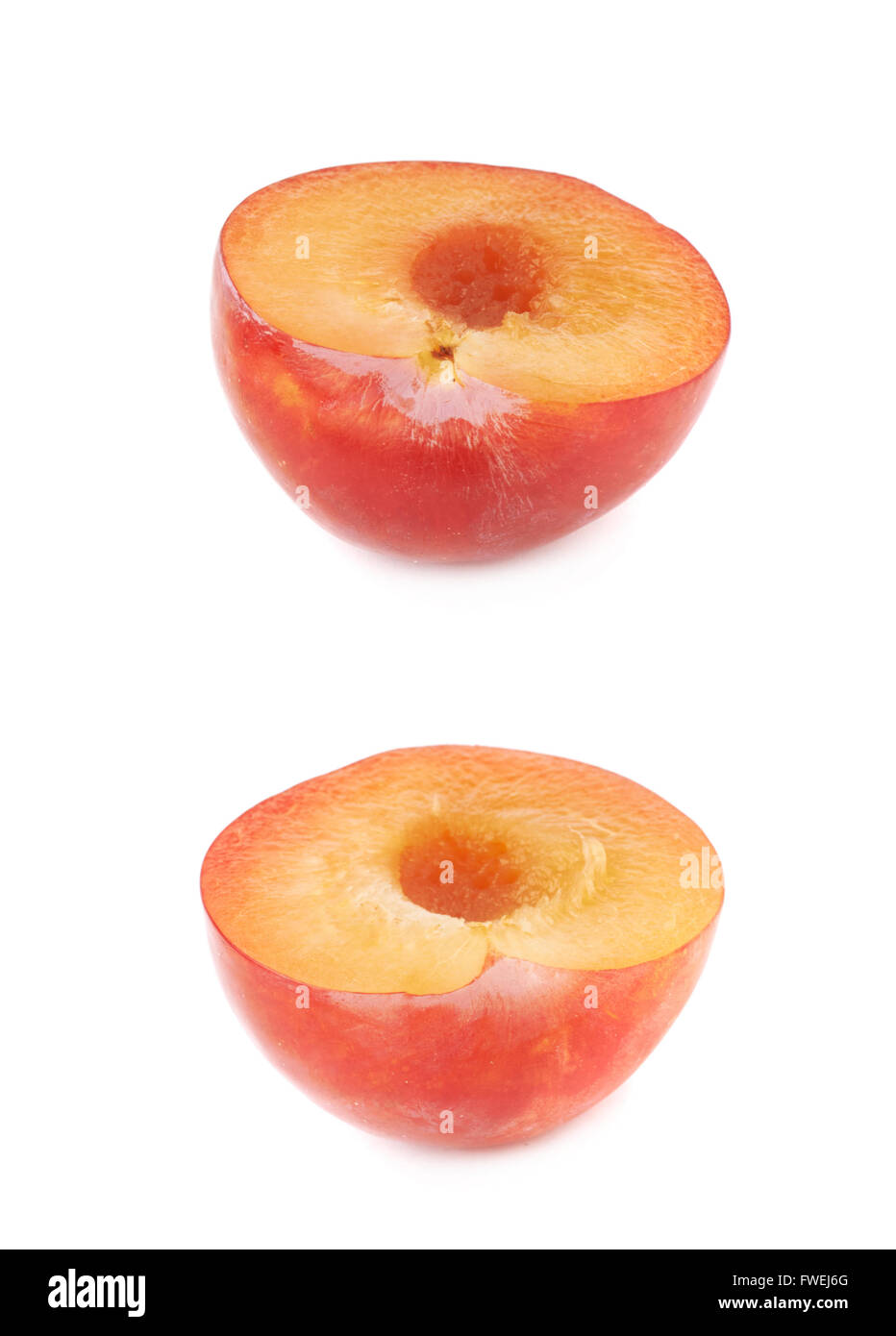Cut open plum half isolated Stock Photo - Alamy