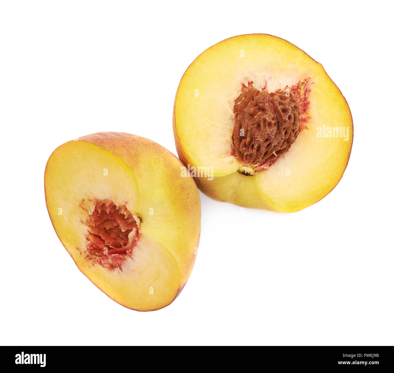 Two halves of a peach fruit isolated Stock Photo - Alamy