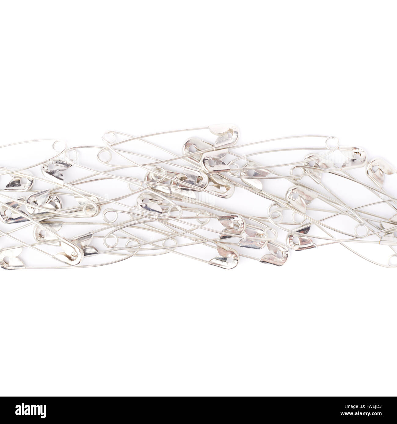 Pile of safety pins isolated on white background Stock Photo - Alamy
