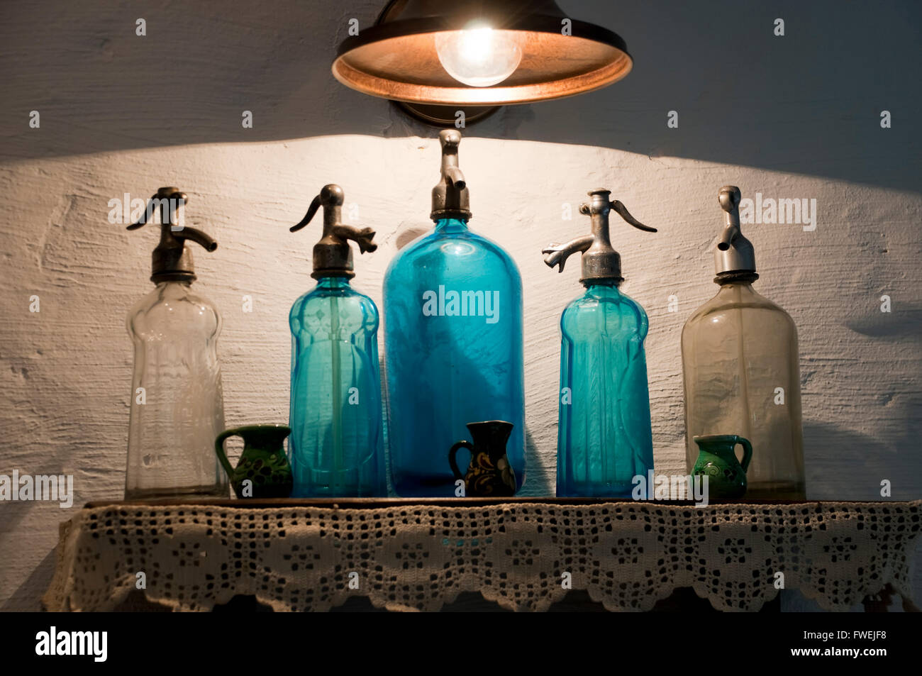 Old fashioned bottles under light of the lamp Stock Photo - Alamy