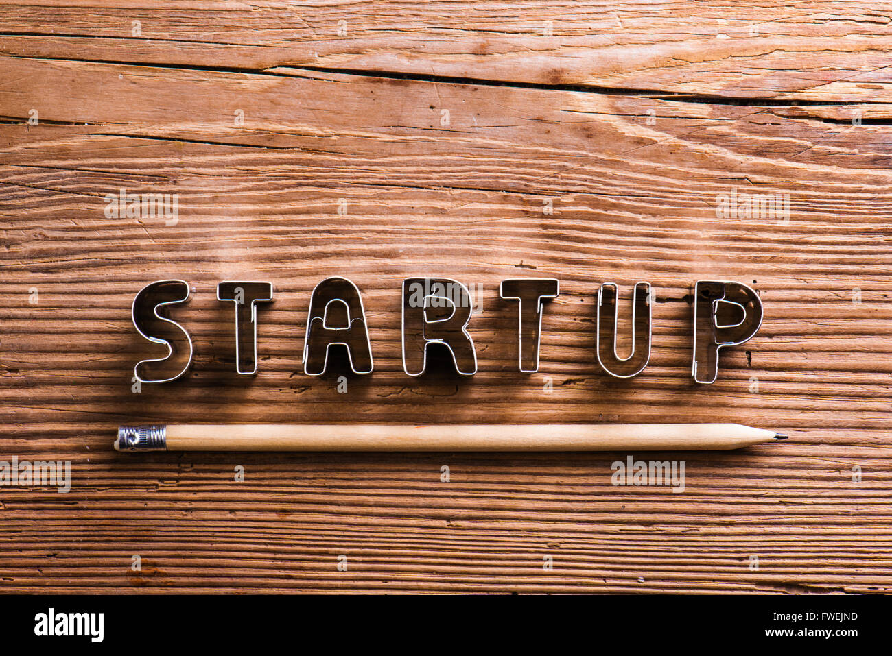 Office desk with start up sign and pencil Stock Photo - Alamy
