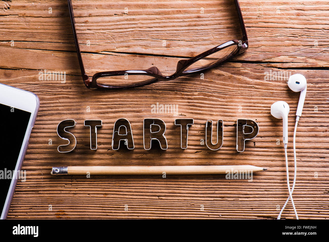 Office desk with start up sign and various objects Stock Photo - Alamy