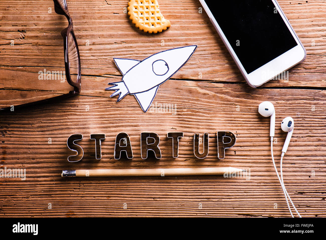 Office desk with start up sign and various objects Stock Photo - Alamy