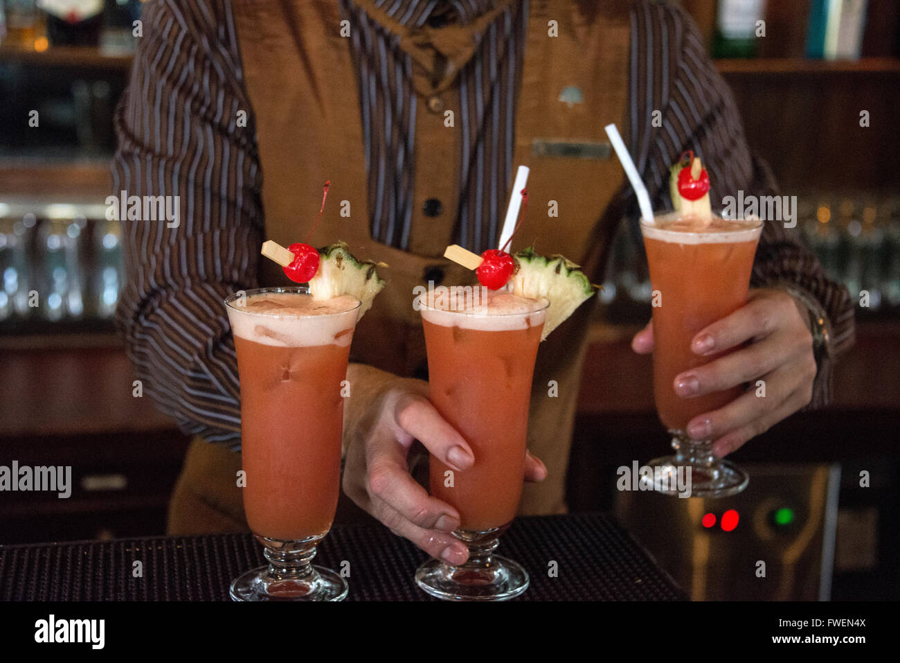 A barman making the famous cocktail drink ,'Singapore Sling' in the ...