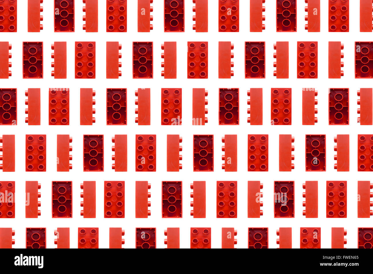 The different sides of a red Lego block photographed against a white ...
