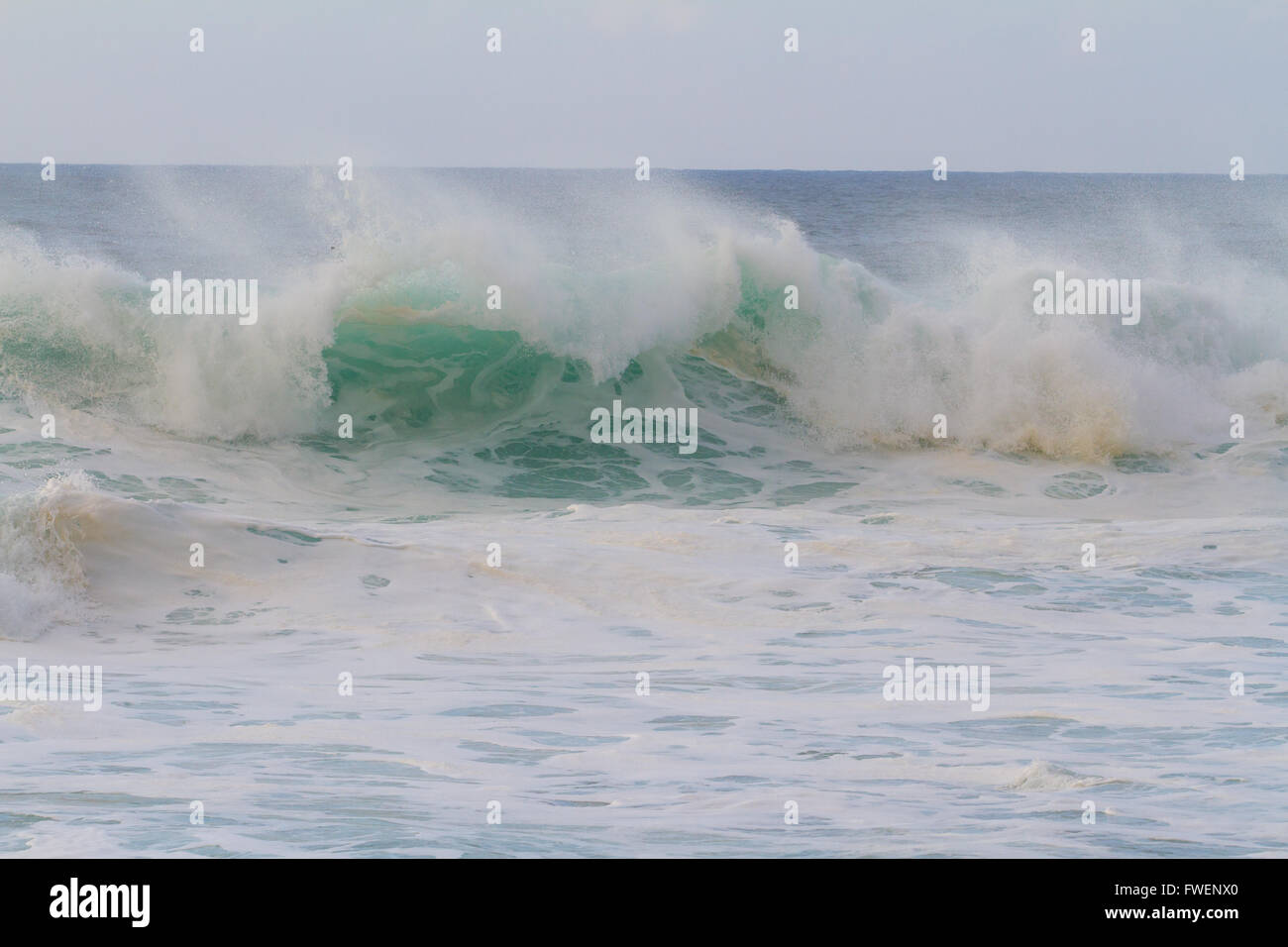 A giant wave breaking during a storm on the north shore of Oahu in ...
