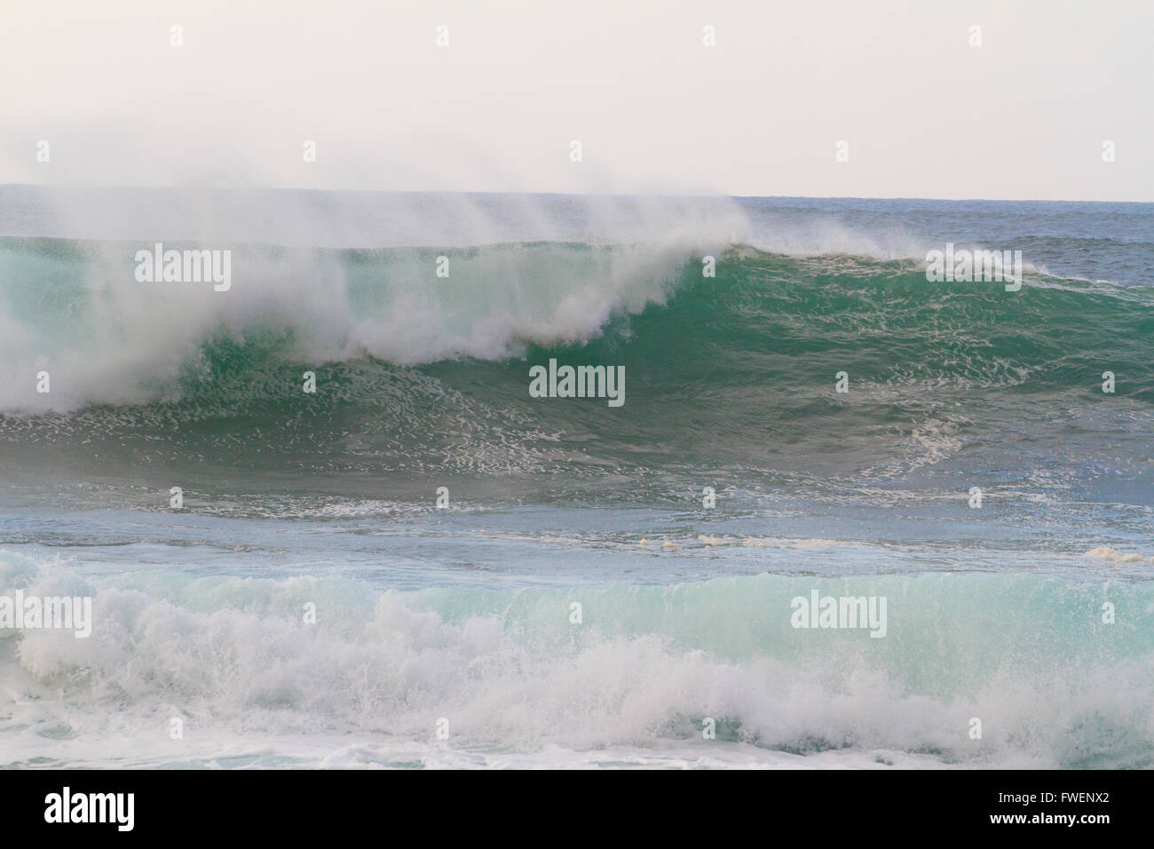 A giant wave breaking during a storm on the north shore of Oahu in ...