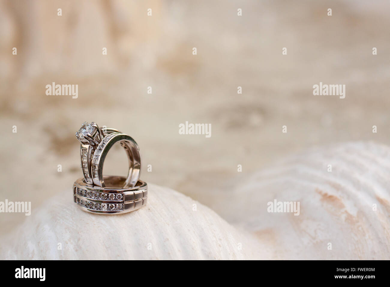 A bride and groom wedding rings photographed in an artistic wedding ...