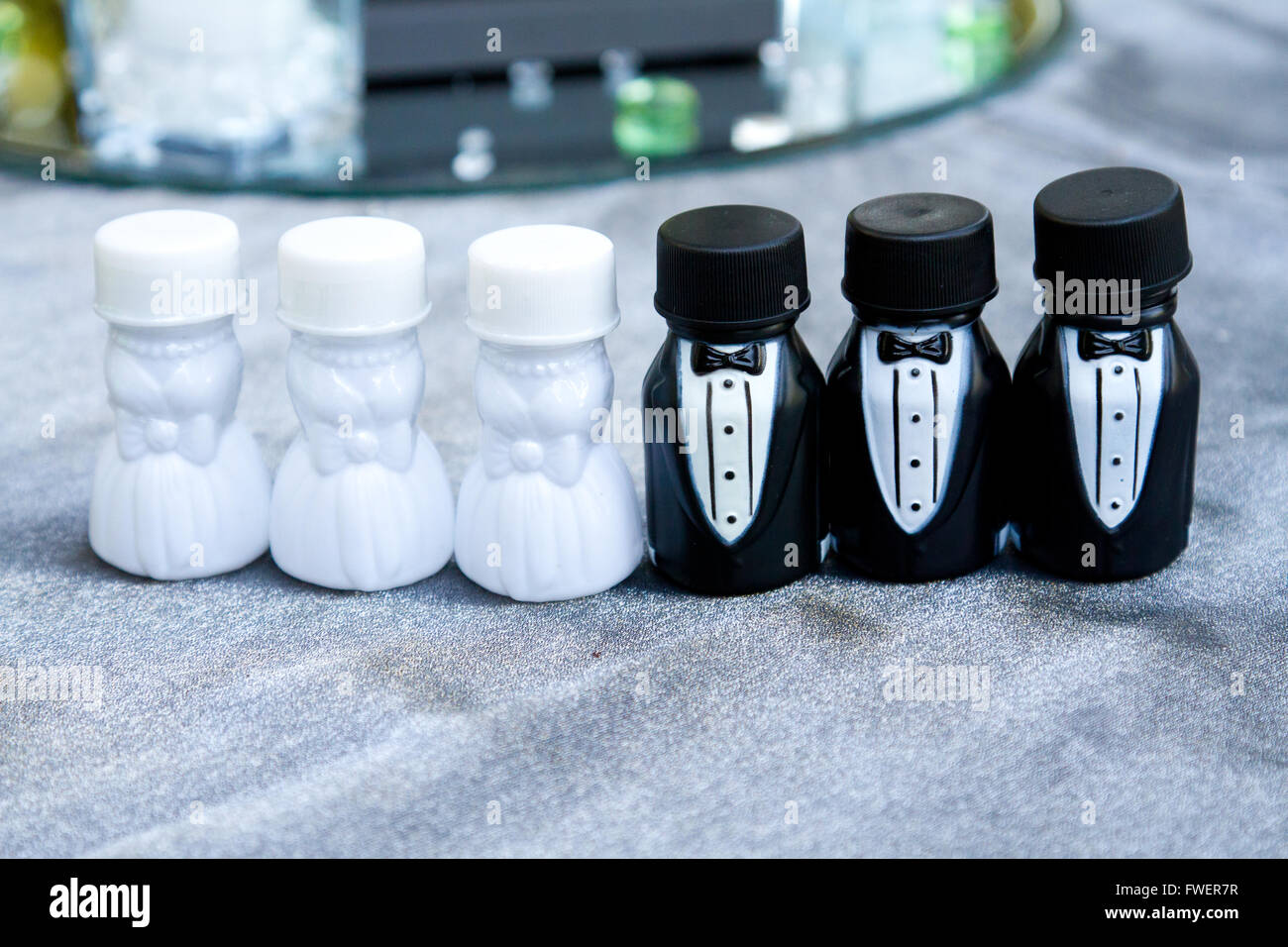 These party favors are containers of bubbles at a wedding. The ...