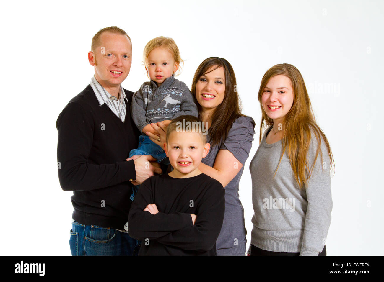 A family of five people on a white isolated background in the studio ...