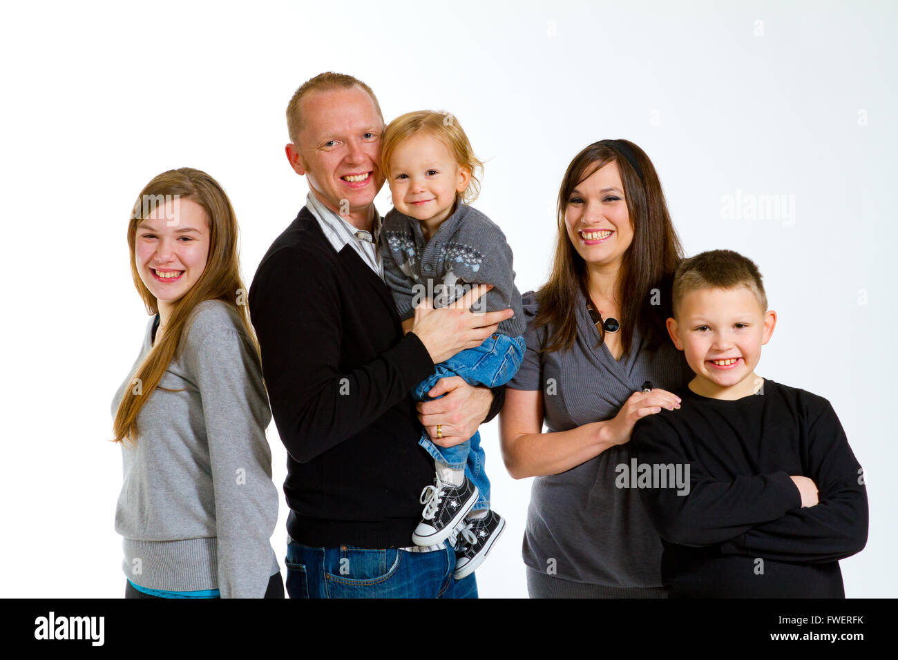 A family of five people on a white isolated background in the studio ...