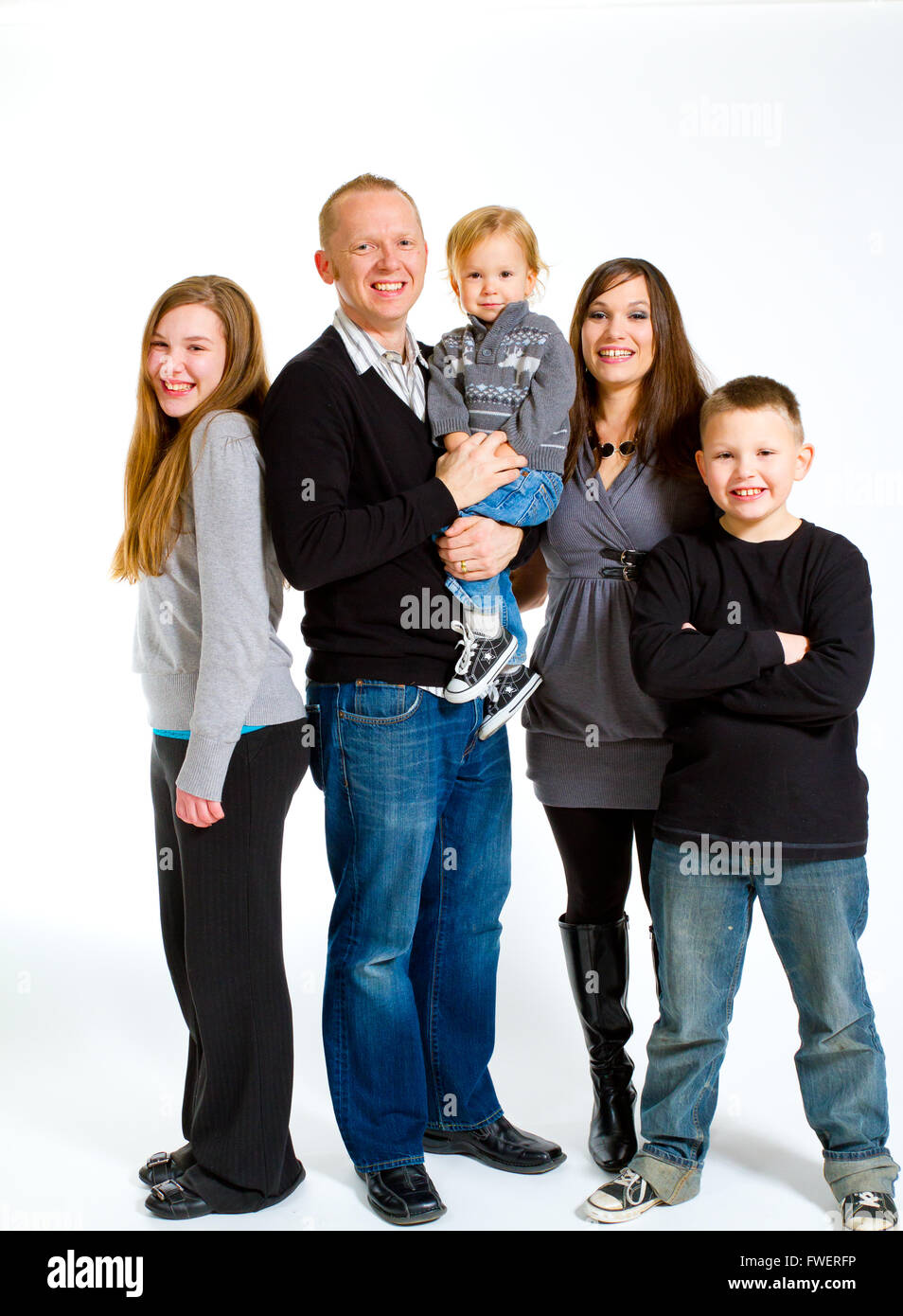 A family of five people on a white isolated background in the studio ...