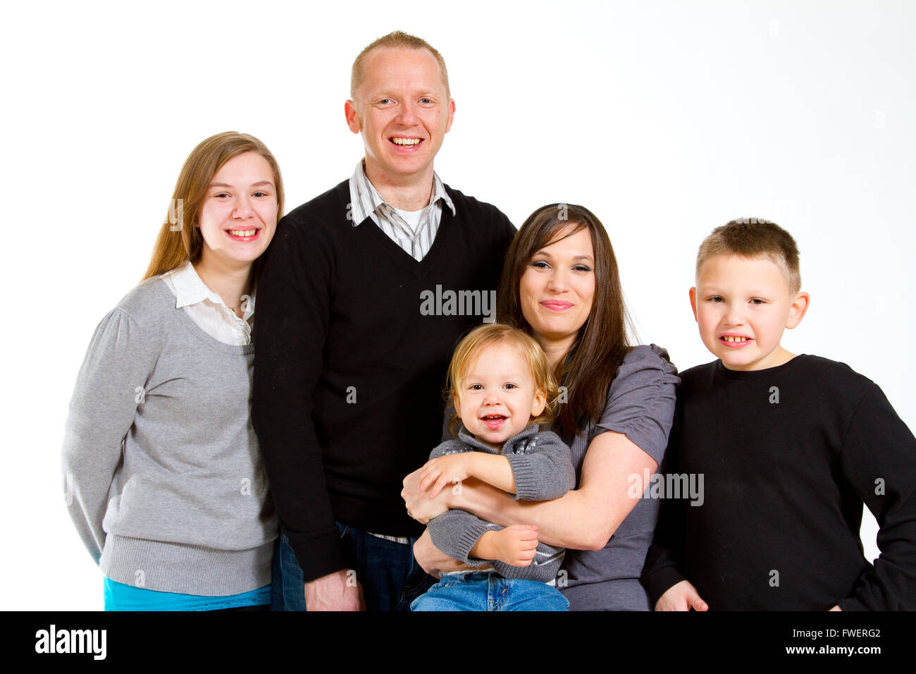 A family of five people on a white isolated background in the studio ...