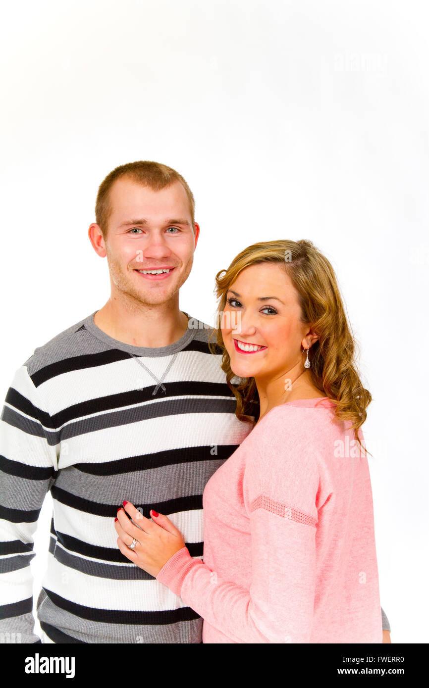 An attractive couple against a white background in the studio to create ...