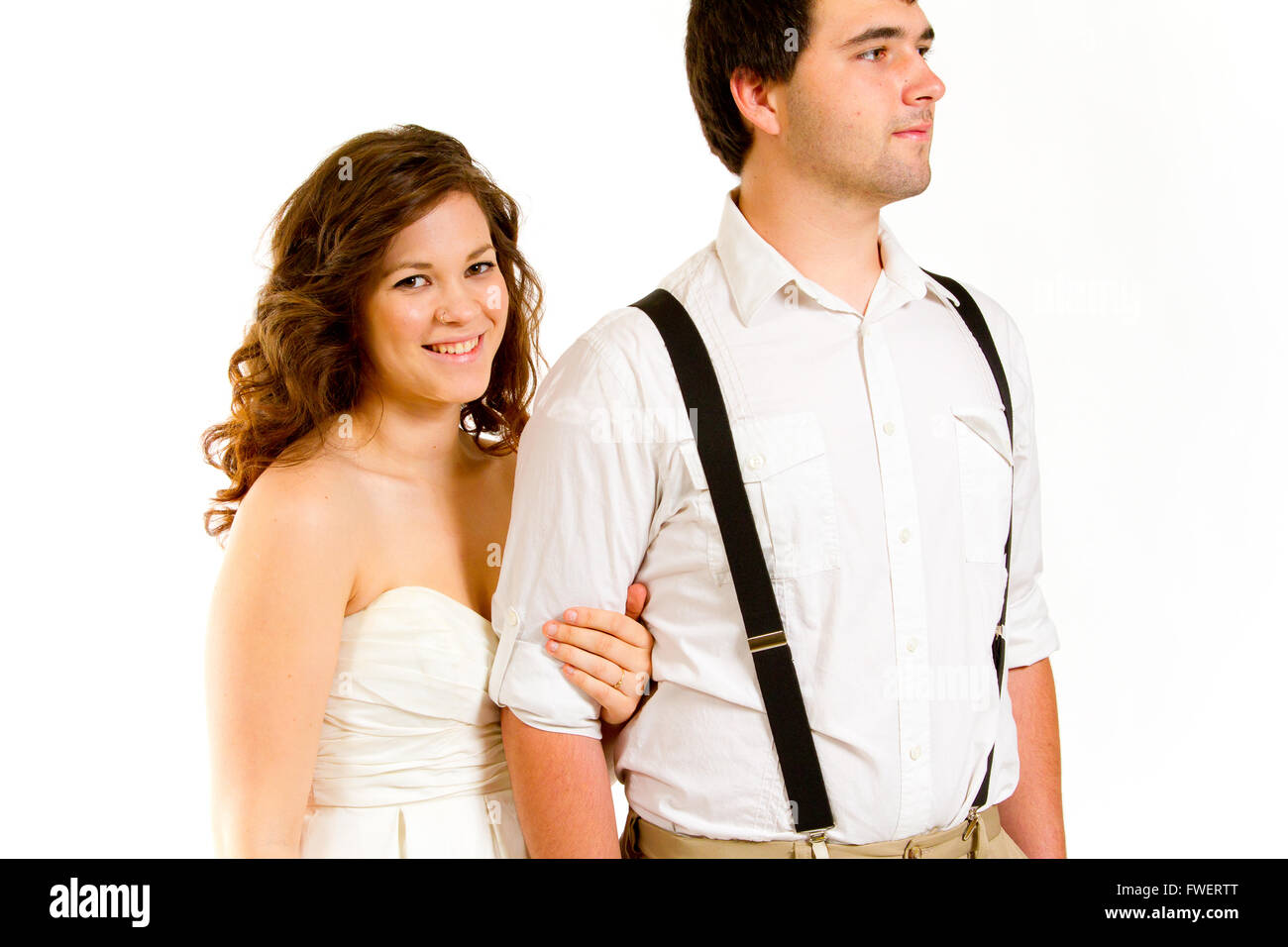 An attractive woman and her handsome husband wear their wedding attire ...