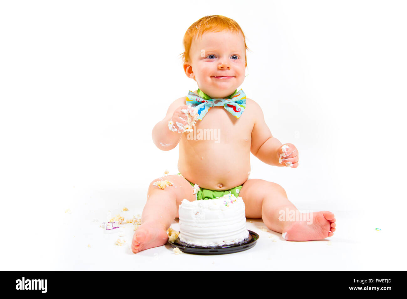A baby boy gets to eat cake for the first time on his first birthday in ...