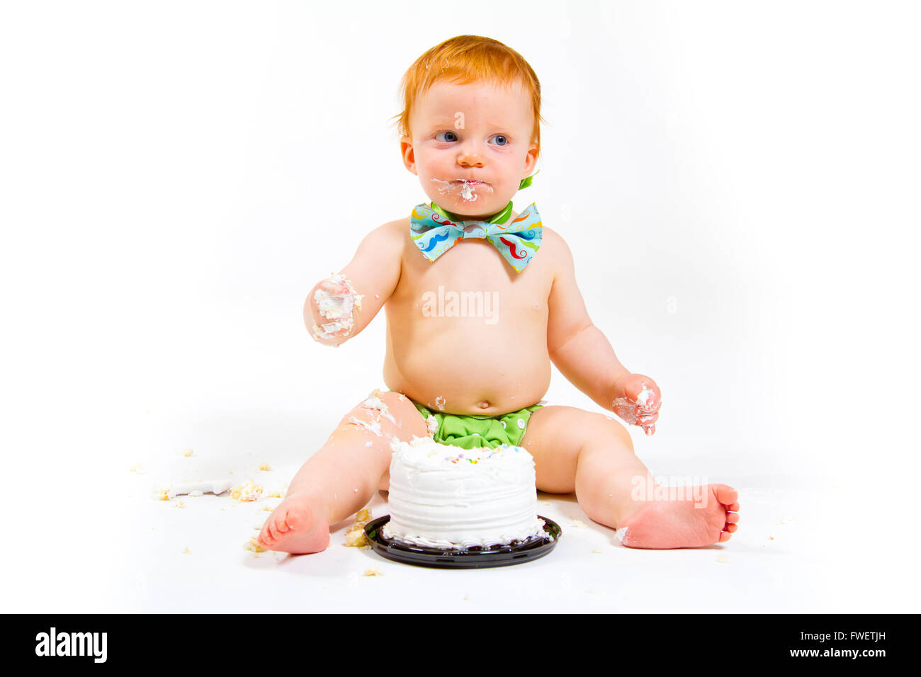 A baby boy gets to eat cake for the first time on his first birthday in ...