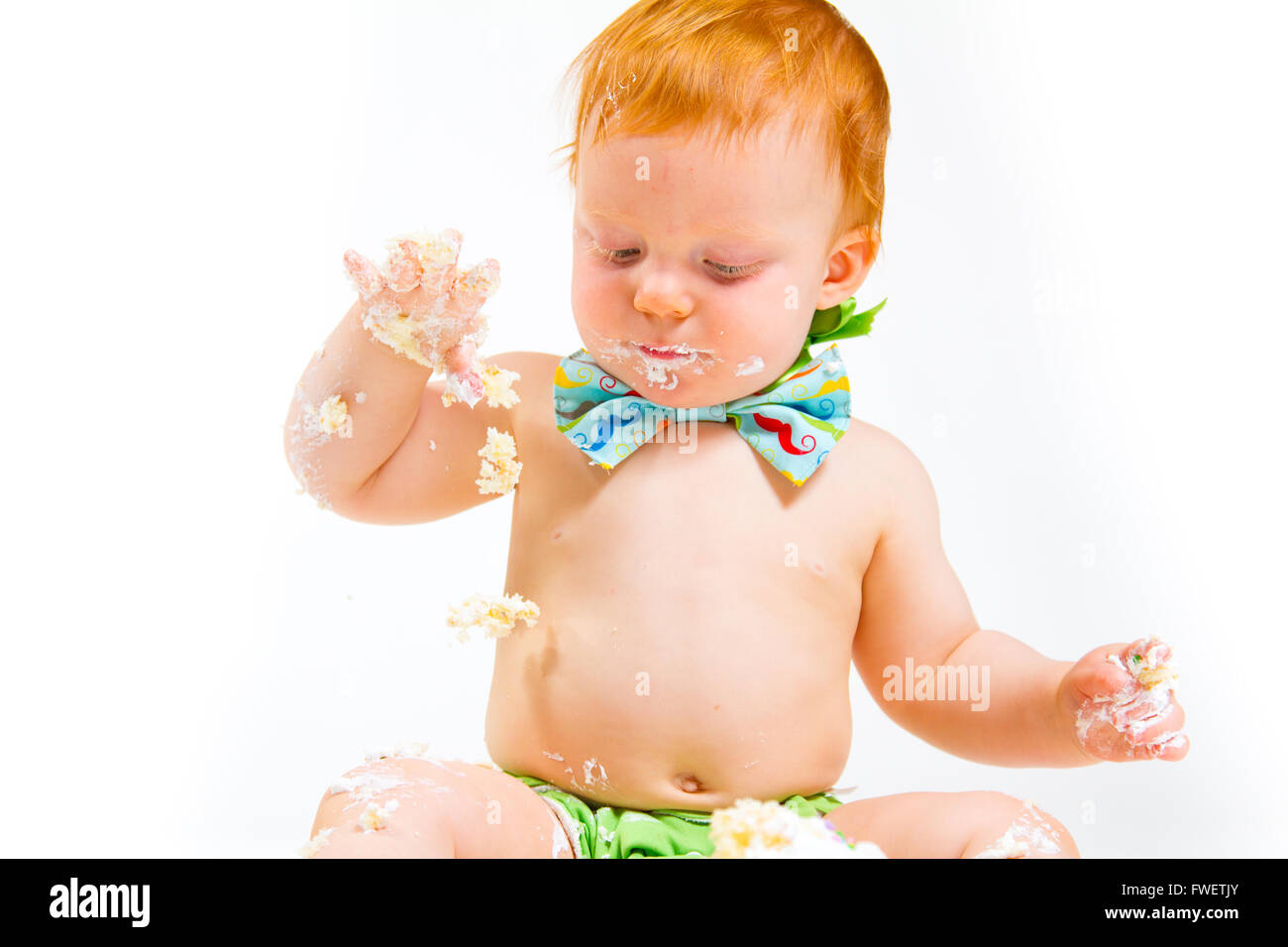 A baby boy gets to eat cake for the first time on his first birthday in ...