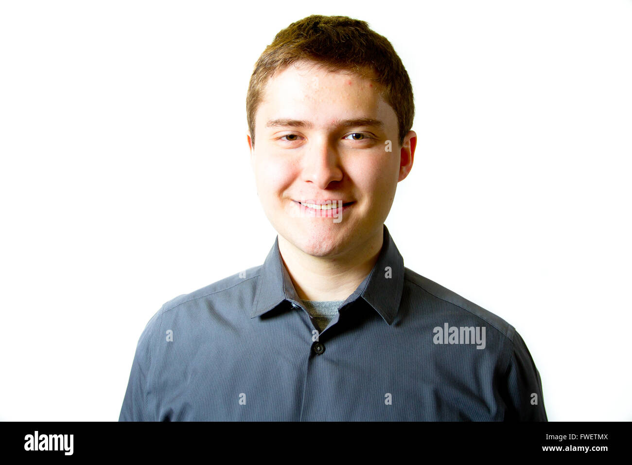 A young adult college student is photographed in the studio agains an ...