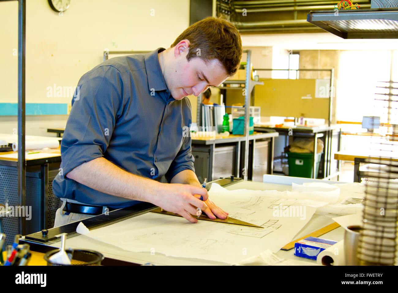 An architect studies in his college work building while drawing plans ...