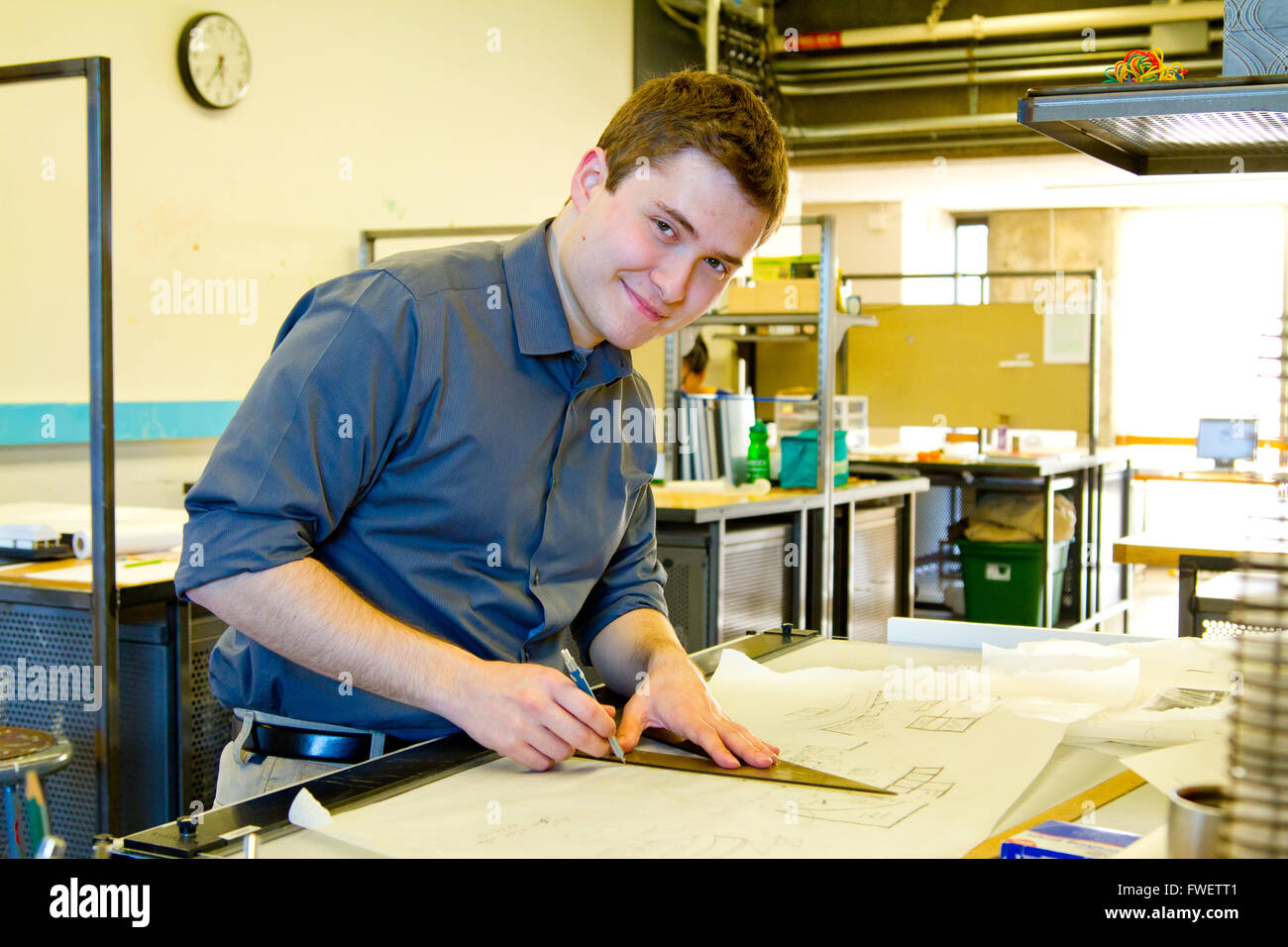 An architect studies in his college work building while drawing plans ...