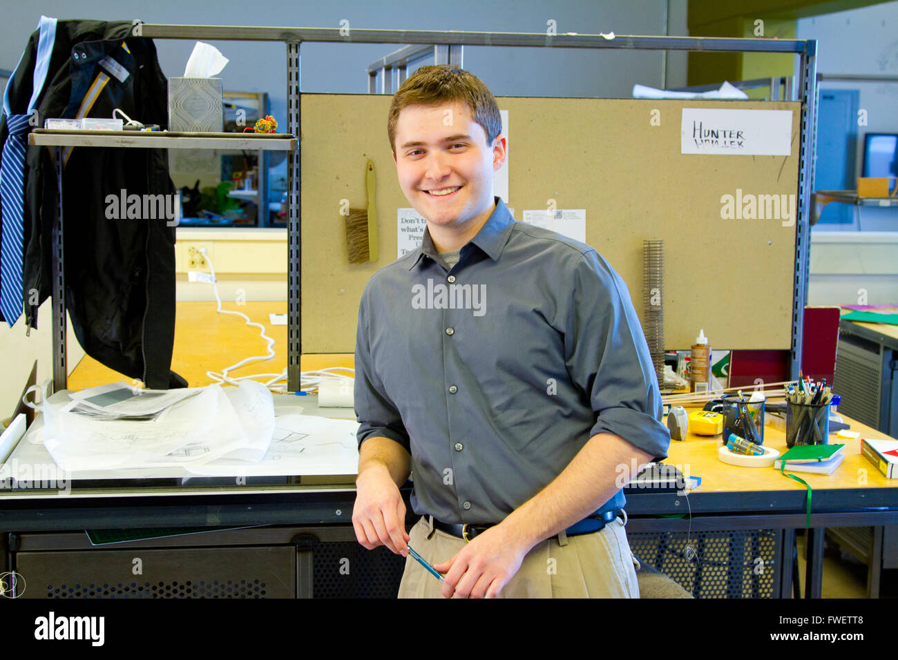 An architect studies in his college work building while drawing plans ...