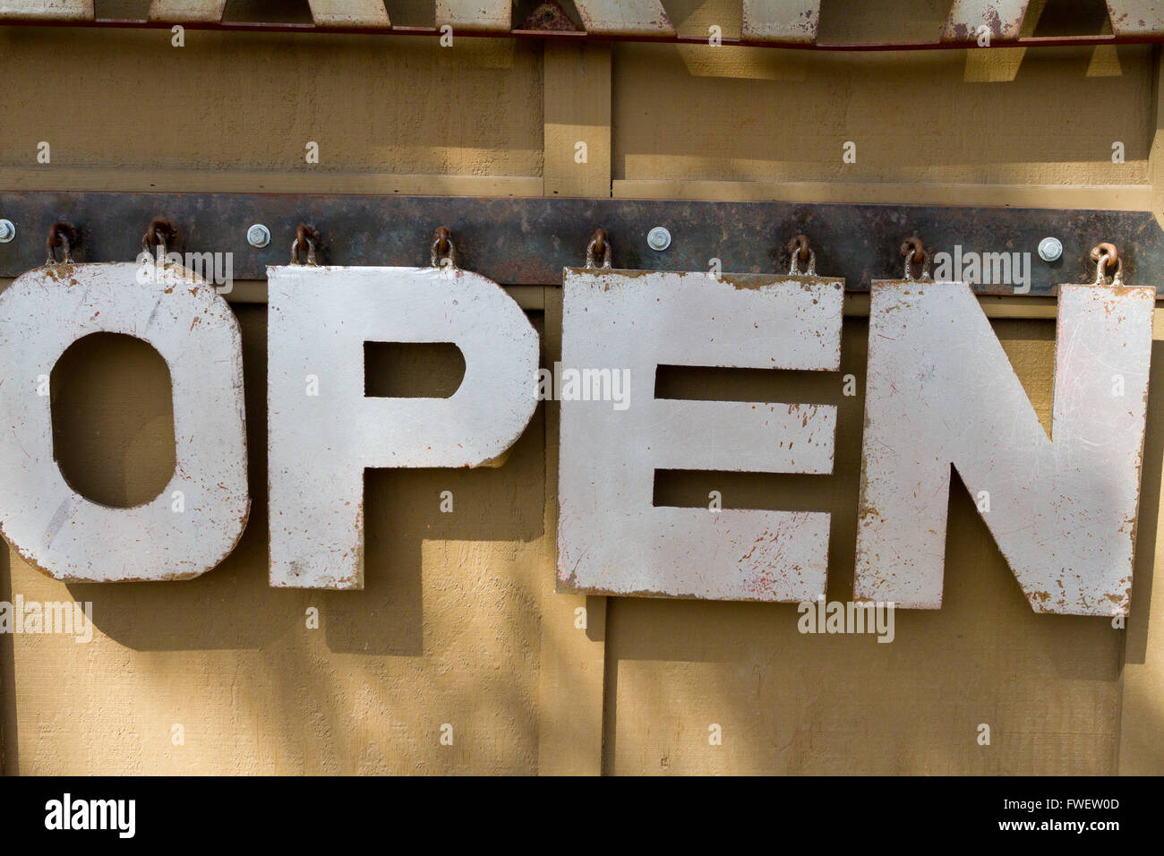 This metal sign is unique and interesting and reads open for customers ...