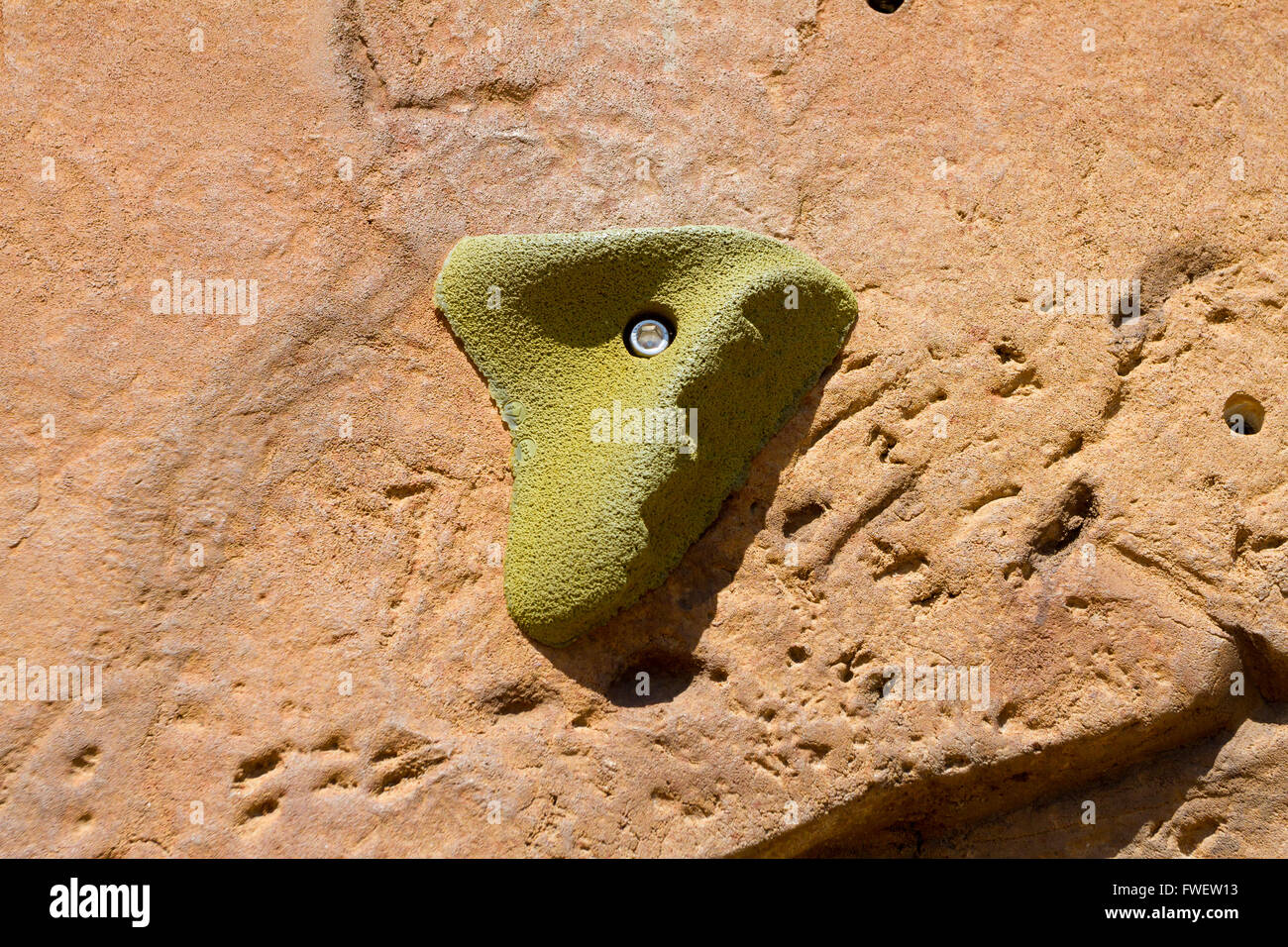 A closeup of a rock climbing wall and the hand holds that are used by ...
