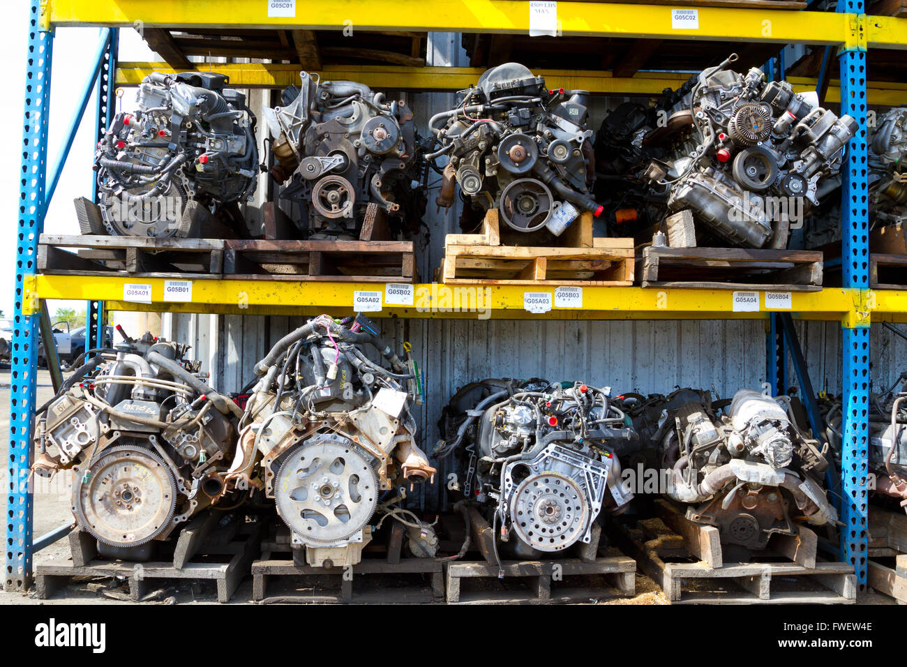 Car and truck engine block motors are lined up at an automobile salvage ...