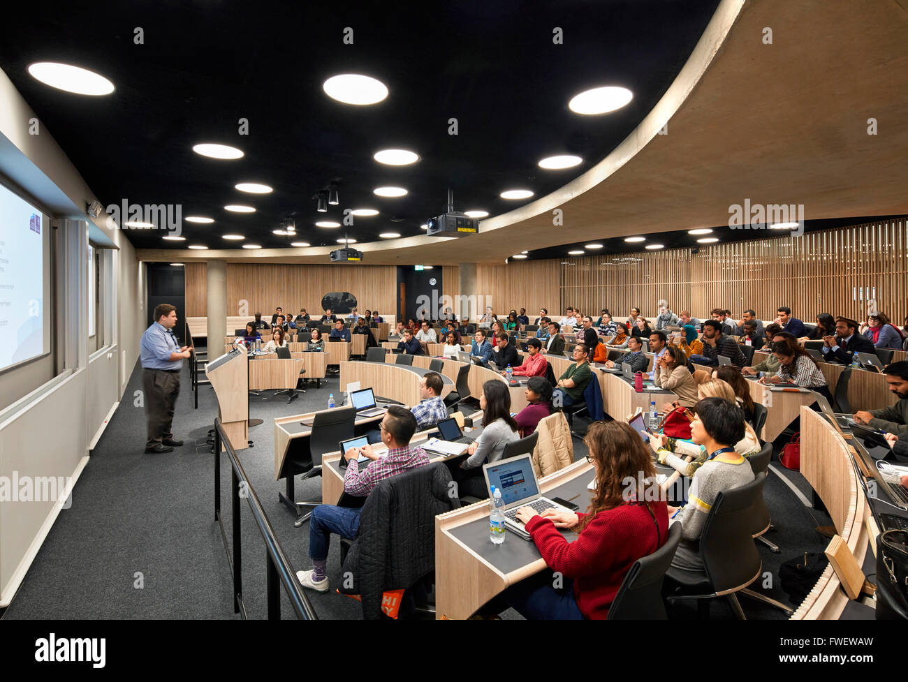 Curved lecture hall with students. The Blavatnik School of Government ...