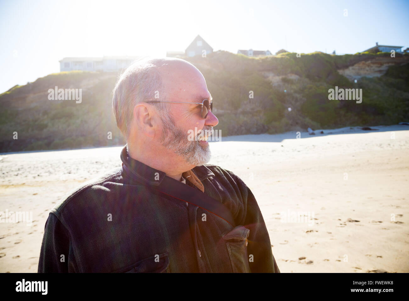 An attractive father faces to his right while the photographer take a ...