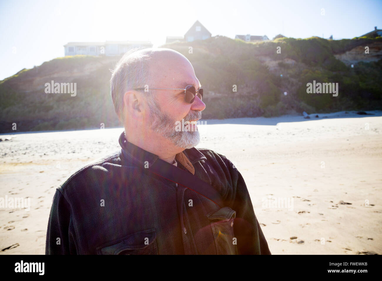 An attractive father faces to his right while the photographer take a ...
