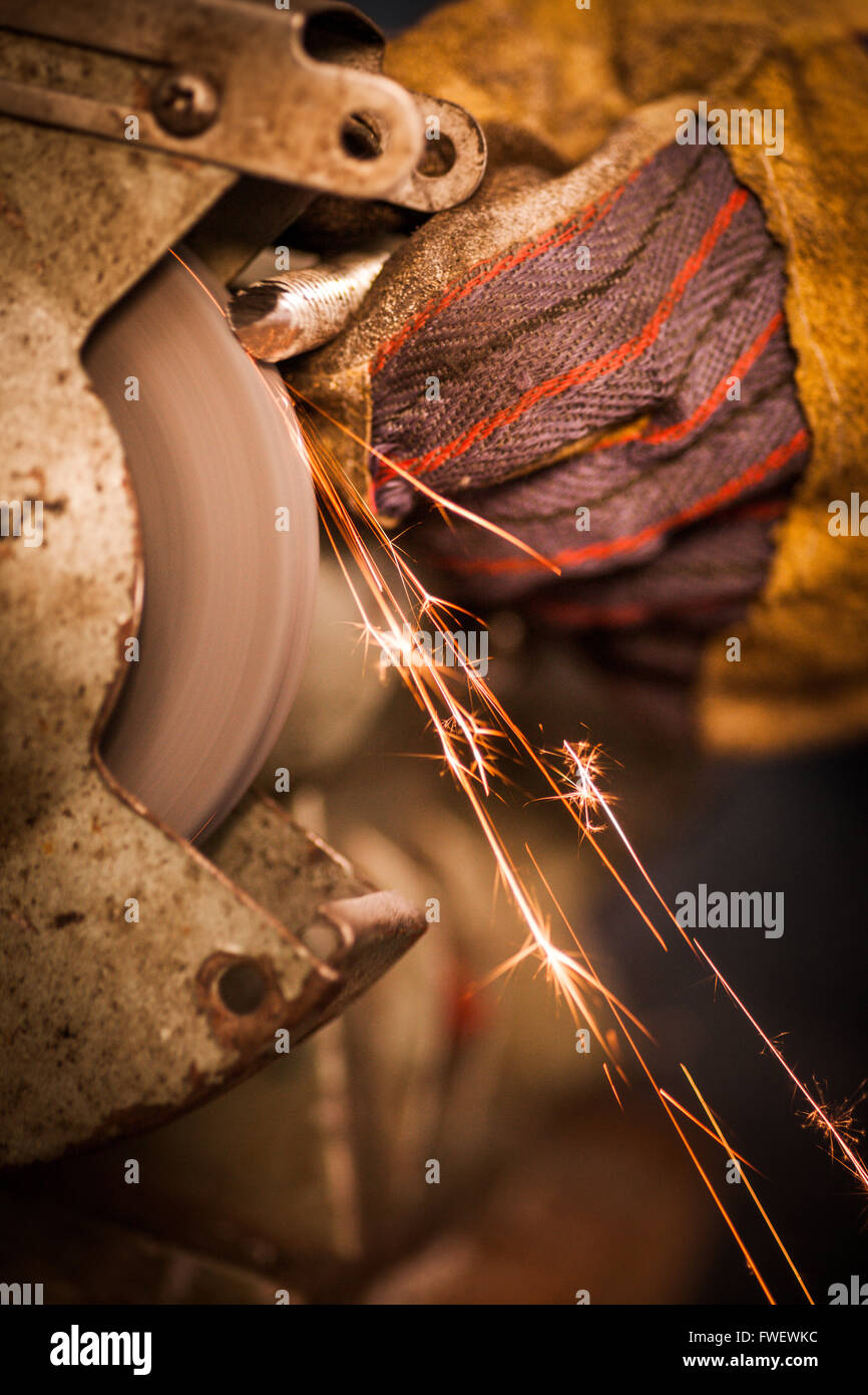 Color image of a hand polishing at a grinder Stock Photo - Alamy