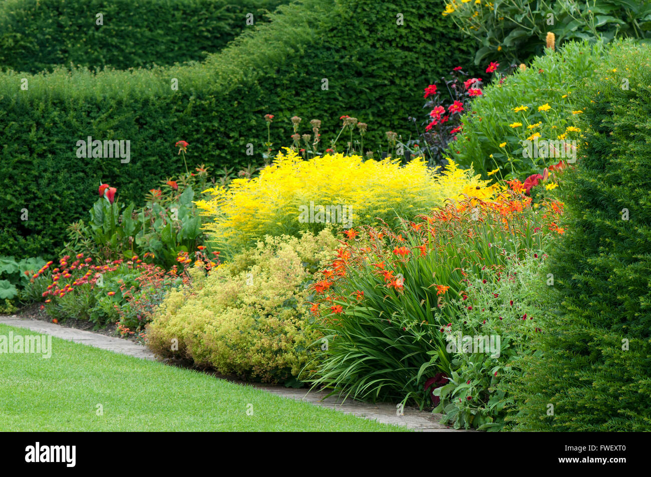 Landscape image showing a colourful border of flowers in a garden in ...