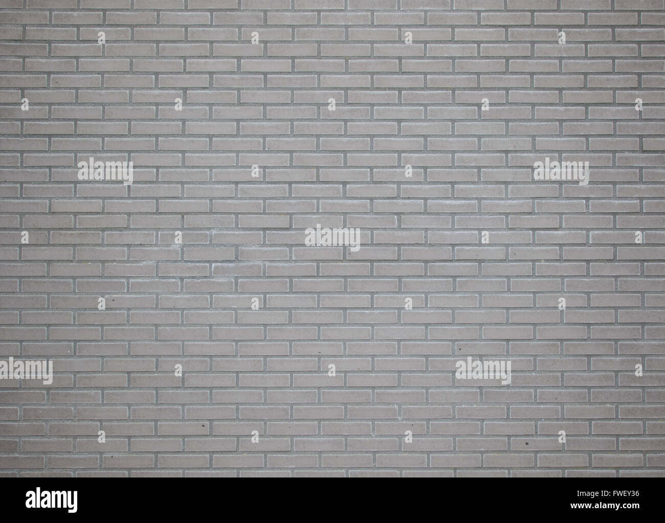 Wall constructed of light grey bricks Stock Photo - Alamy
