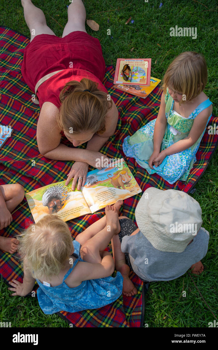 A mother reads a story to a group of children Stock Photo - Alamy