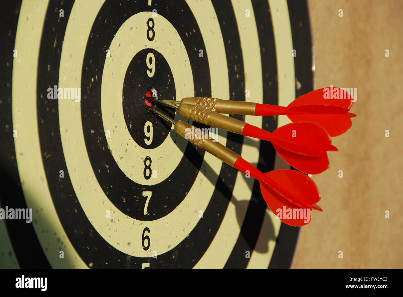 Red darts hitting target Stock Photo - Alamy