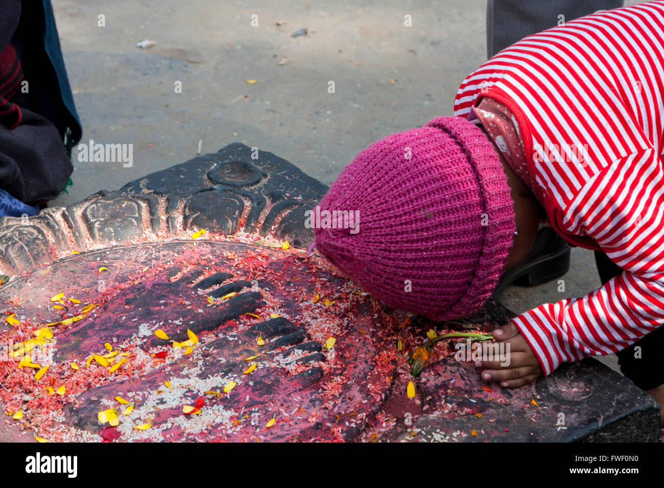 Nepal, Kathmandu, Swayambhunath. Worshiper Bowing to the Feet of Buddha ...