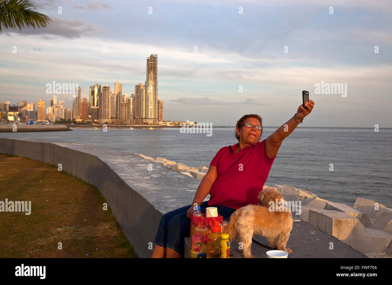 Woman photographing self with cell phone at the Punta Paitilla, Panamá ...