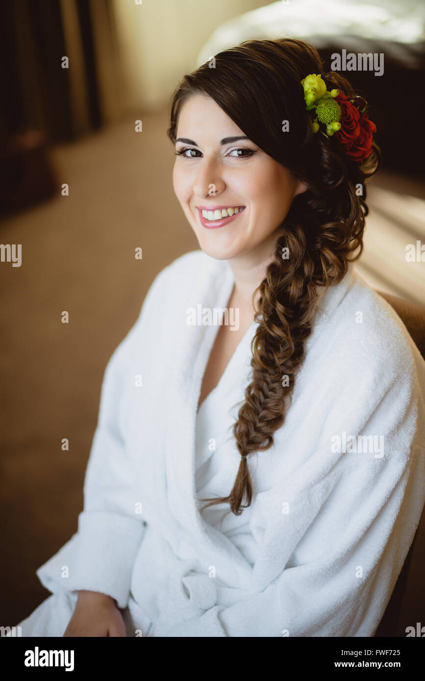 bride sits on a chair in white robe Stock Photo - Alamy