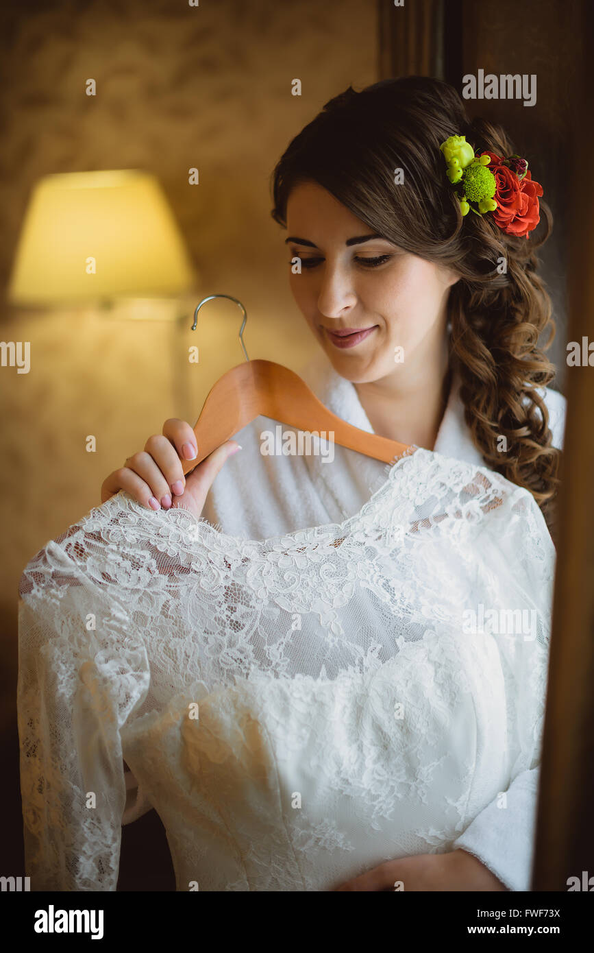 Bride holding wedding dress Stock Photo - Alamy
