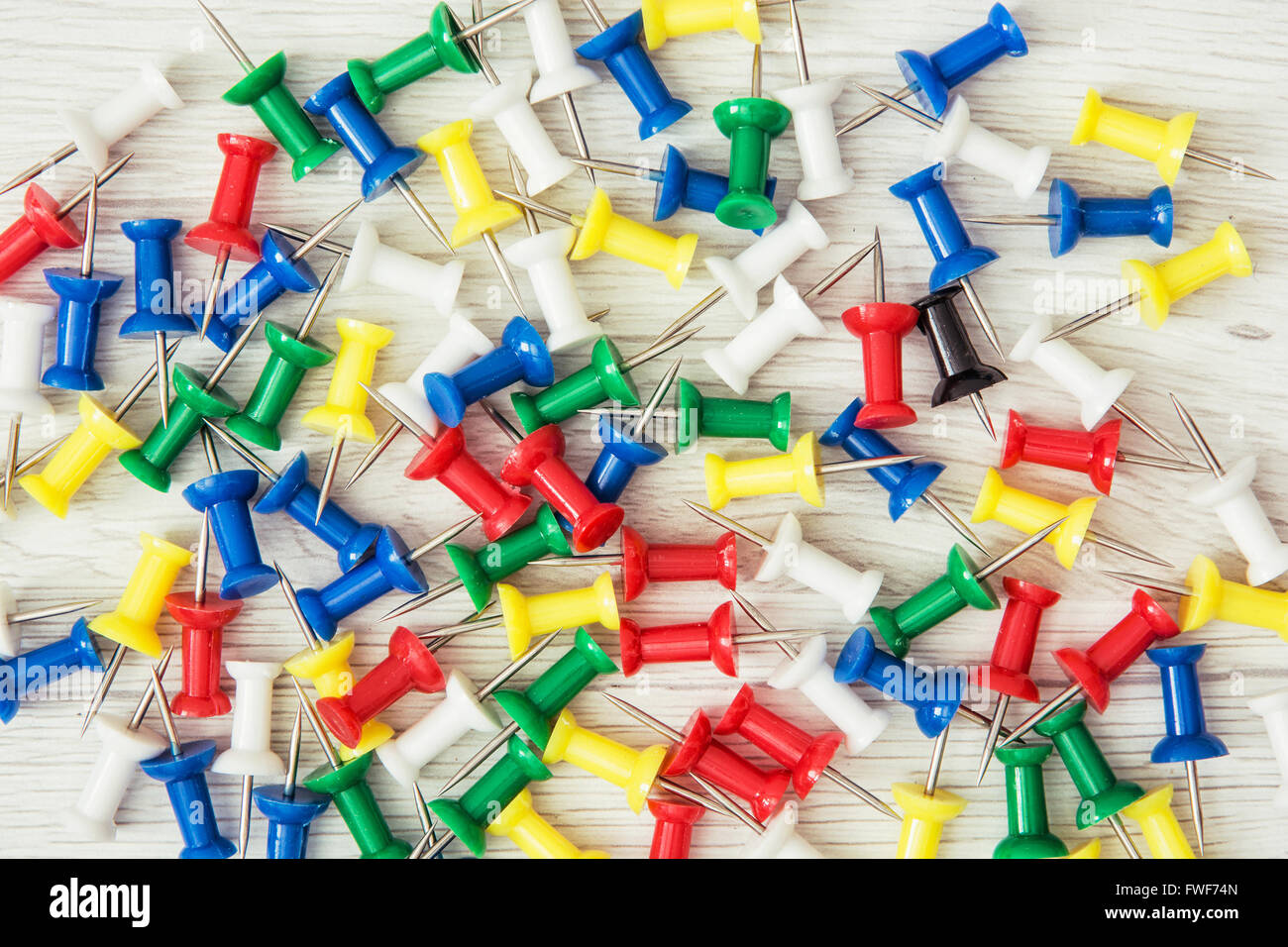 Background of coloured thumbtacks - office push pins. Office supplies ...