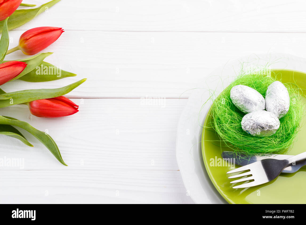 Easter table setting on white wooden table Stock Photo - Alamy
