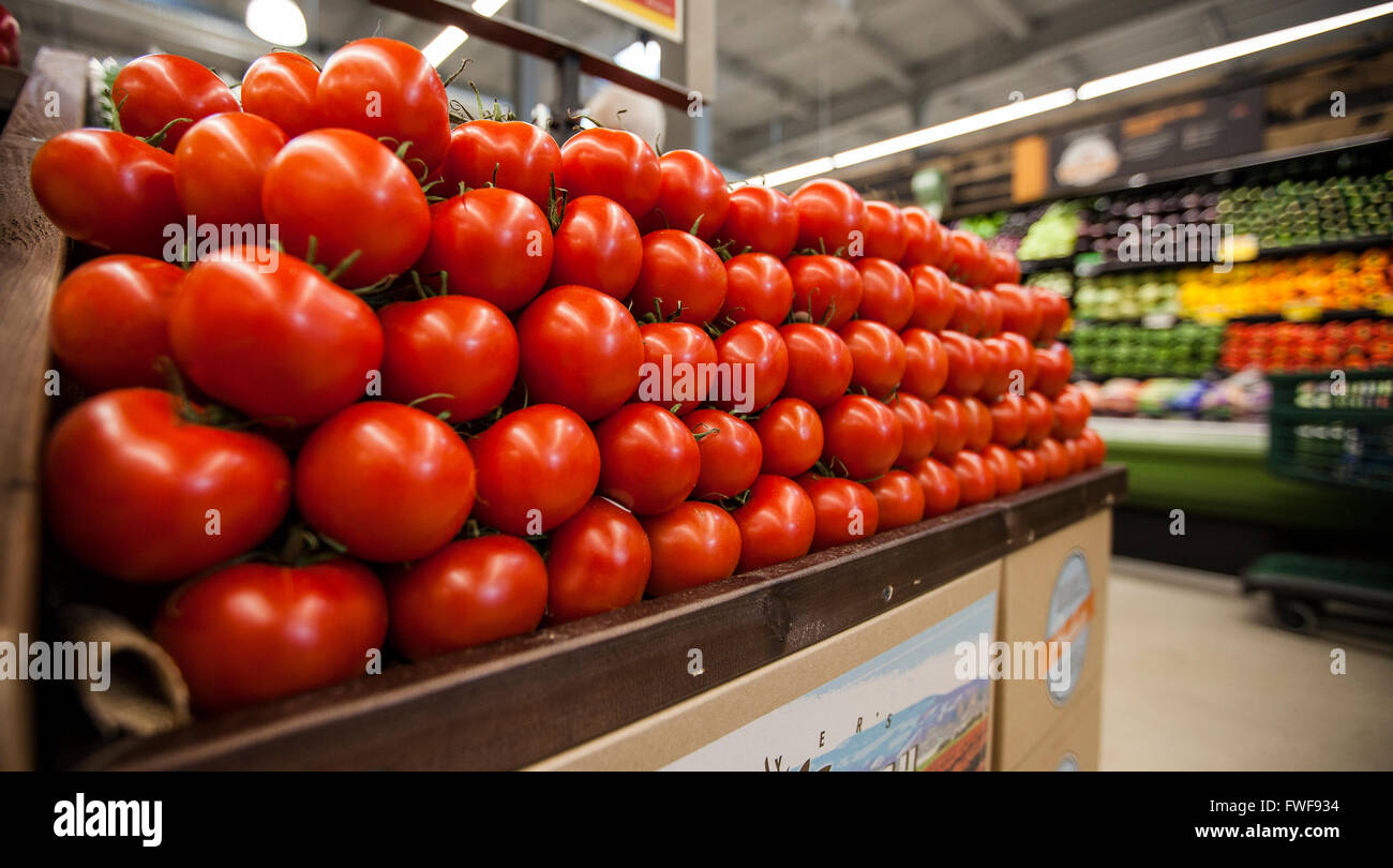 a display of red tomatoes at a Whole Foods Market in the produce ...