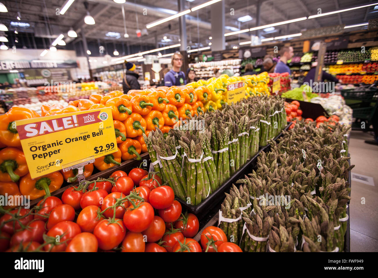 stacks of fresh produce on display at a natural foods grocery store ...