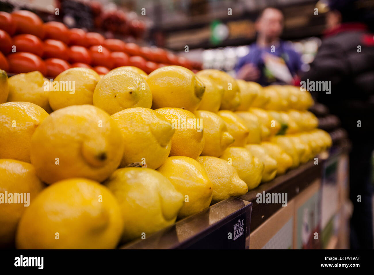 A stack of rows of lemons in the produce section of a grocery store ...