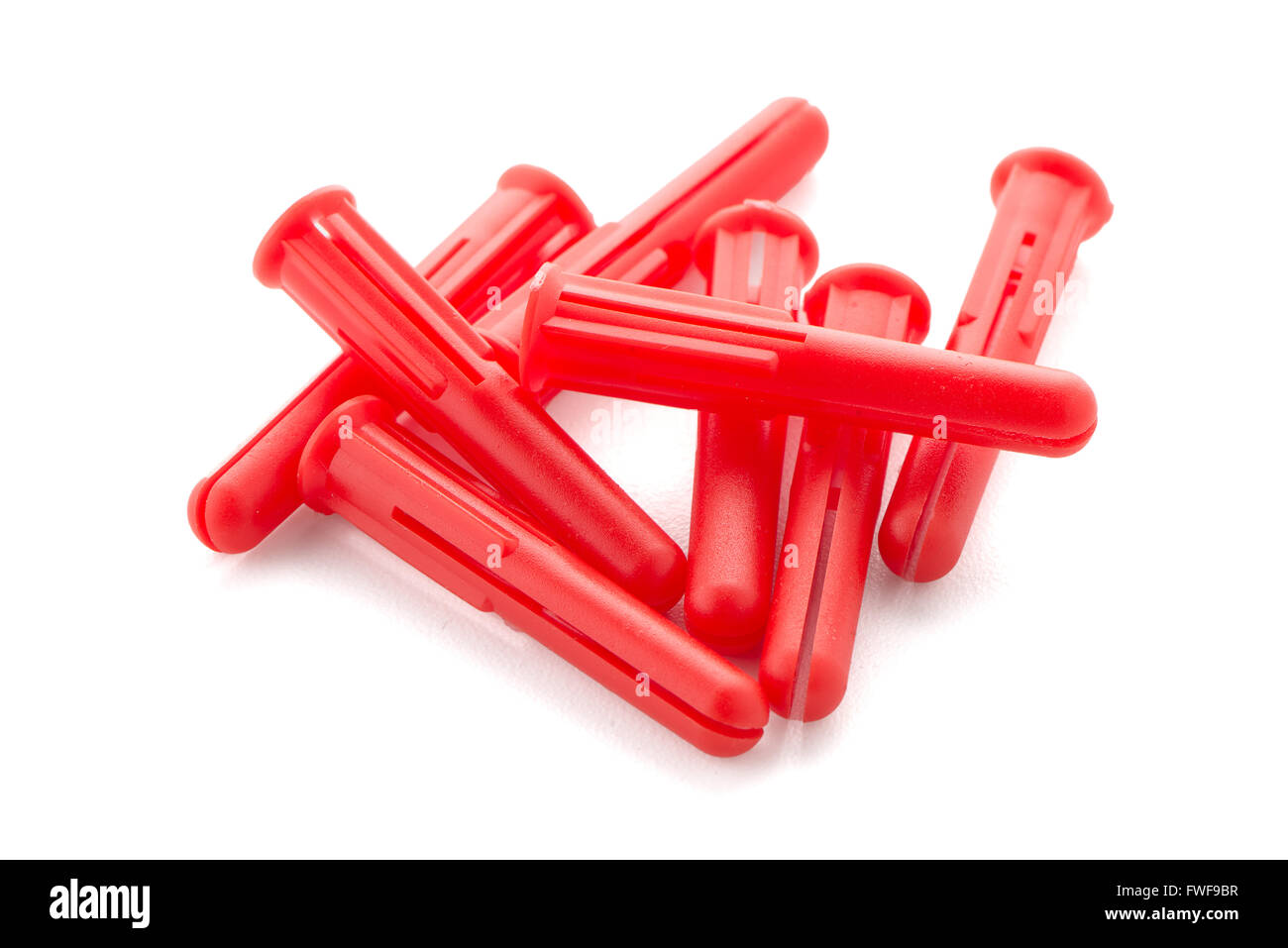 Red plastic dowels isolated on white background Stock Photo - Alamy