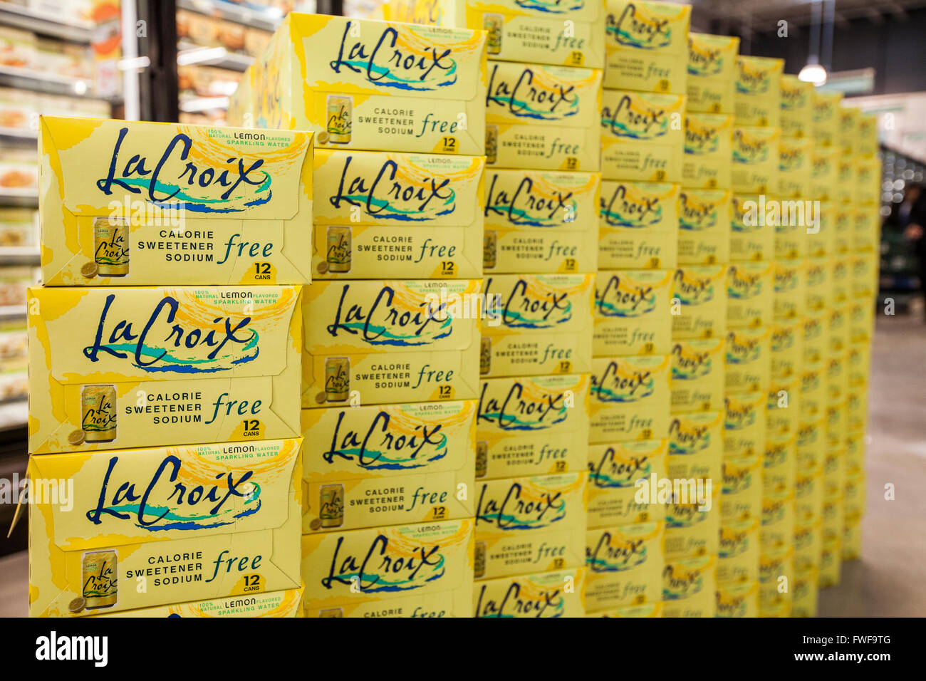 cases of La Croix sparkling water stacked in a grocery store aisle ...