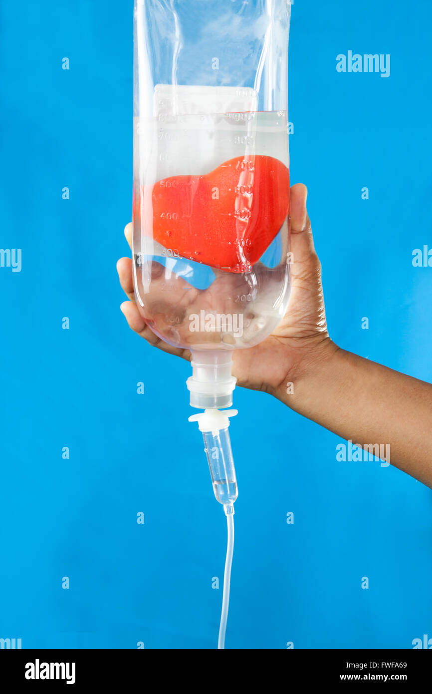 handle saline solution injection and inner red heart on blue cloth ...